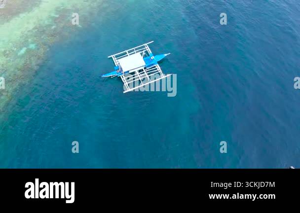 Aerial view of a traditional blue Filipino outrigger boat banca ...