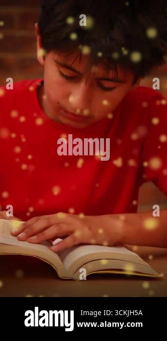 Animation of glowing spots over asian boy reading book. international ...