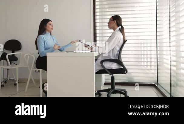 Young female Latin patient talking to doctor on consultation meeting in ...