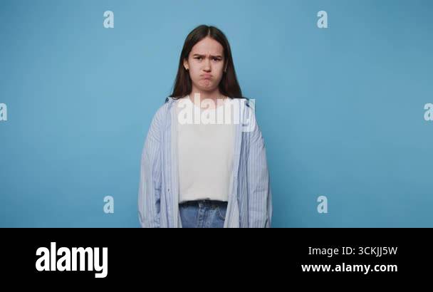 footage of young girl looks somber with a serious expression, showing a ...