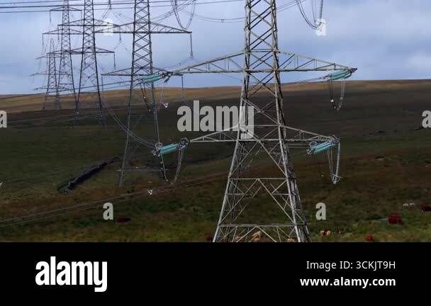 Wide shot of electricity pylons crossing Rishworth Moor, West Yorkshire ...
