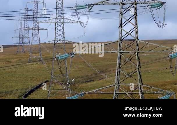 Wide shot of electricity pylons crossing Rishworth Moor, West Yorkshire ...