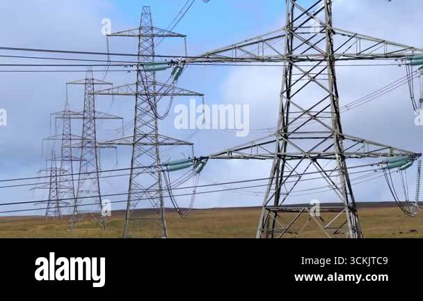 Wide shot of electricity pylons crossing Rishworth Moor, West Yorkshire ...