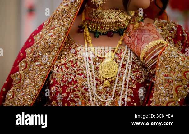 The bride is dressed in traditional red Asian clothes with beautiful ...