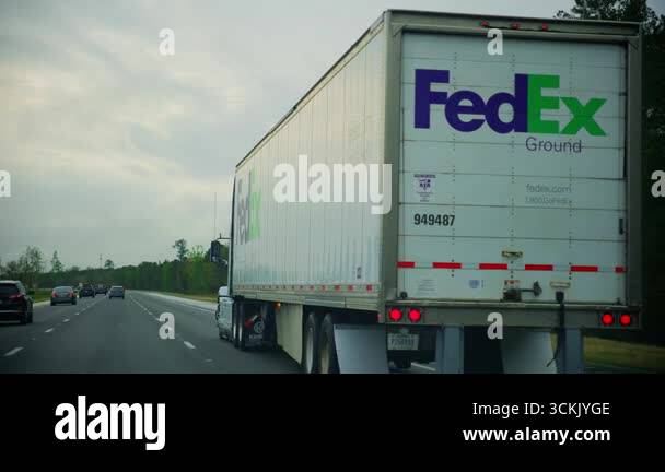 Close up POV view of FedEx delivery truck driving on highway surrounded ...