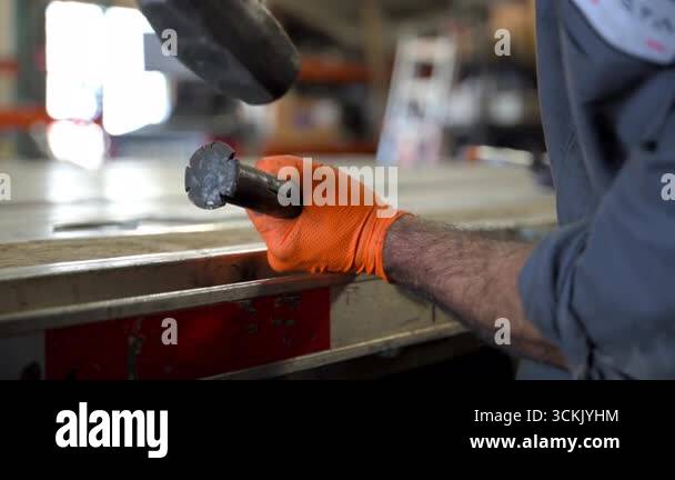 Welder at work, wearing protective gear, welding helmet and heavy-duty ...