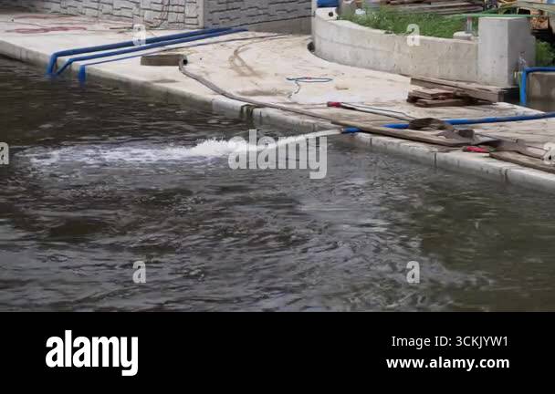 Riverside of flooded river with the yellow caution tape waving by wind ...