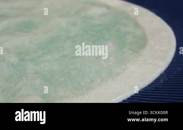 jacuzzi. Close-up macro view of foam and bubbles on water surface ...