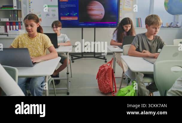 Elementary School Children Using Laptops, Doing Creative Tasks During Digital Art Lesson in ...