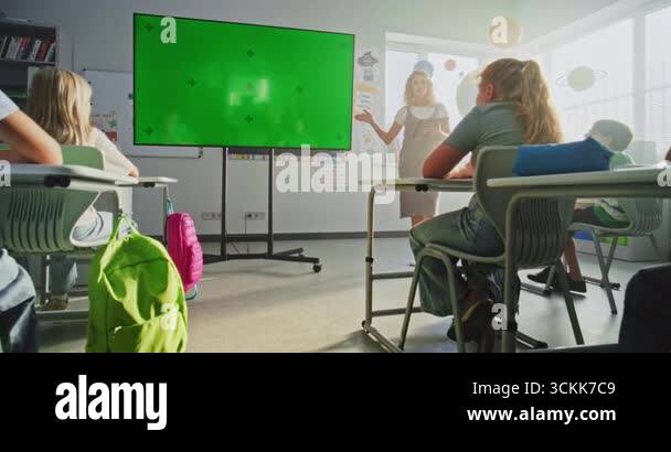 Female Teacher with Tablet Computer Educating Elementary School ...