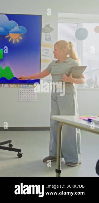 Primary School Girl with Tablet Computer Showcasing Knowledge of ...