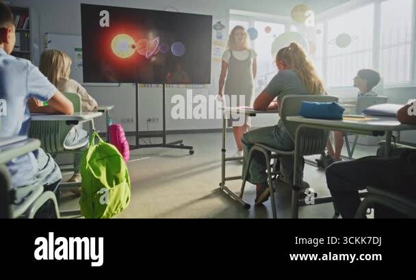 Astronomy Class: Female Teacher Explaining Solar System to Primary School Children Using Digital ...
