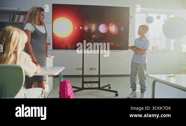 Elementary School Boy with Tablet Computer Giving Presentation About ...