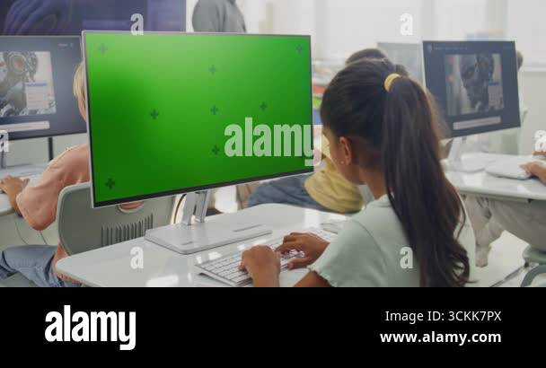 Elementary School Girl Using Computer with Green Screen Template for ...