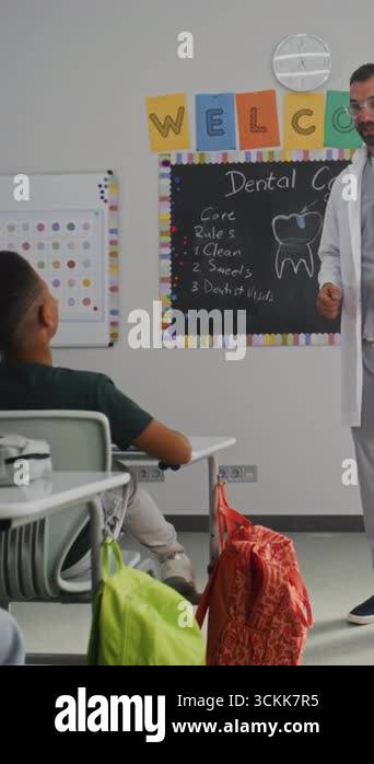 Healthcare Professional Explaining Dental Care Rules to Students ...