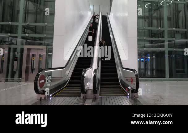 Person descending on an escalator in a contemporary setting Stock Video ...