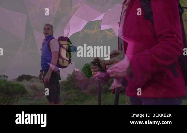Network overlay fading, revealing hiking couple exchanging glance and ...