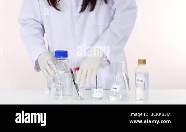 Scientist preparing a chemistry experiment with solutions Stock Video ...