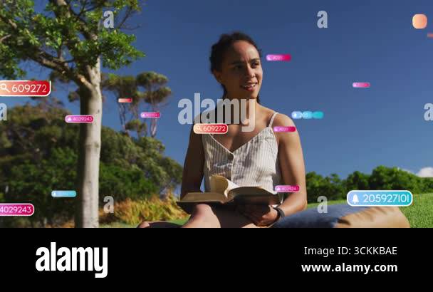 Woman unfolding legs on grassy hillside and reading book, drawing ...