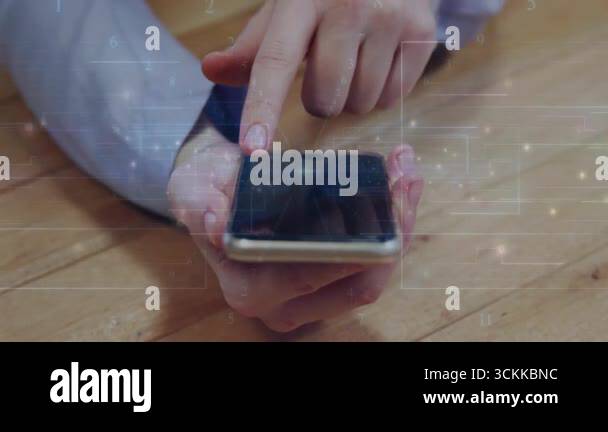Hand holding smartphone above desk while finger tapping and sliding ...