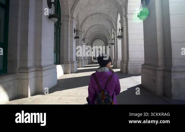 Woman walking down arches outside at Washington Union Station in ...