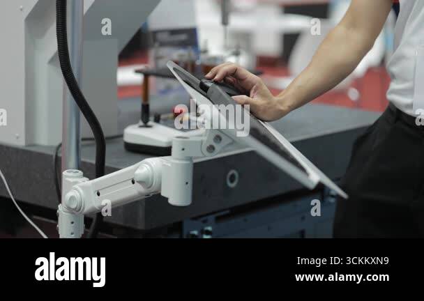 Close up of engineer using touchscreen control panel in modern factory ...