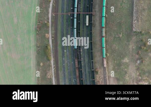 An aerial drone view of railway carriages at the station waiting inline ...