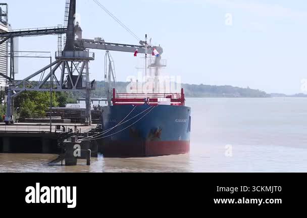 A cargo ship docking at an industrial port Stock Video Footage - Alamy