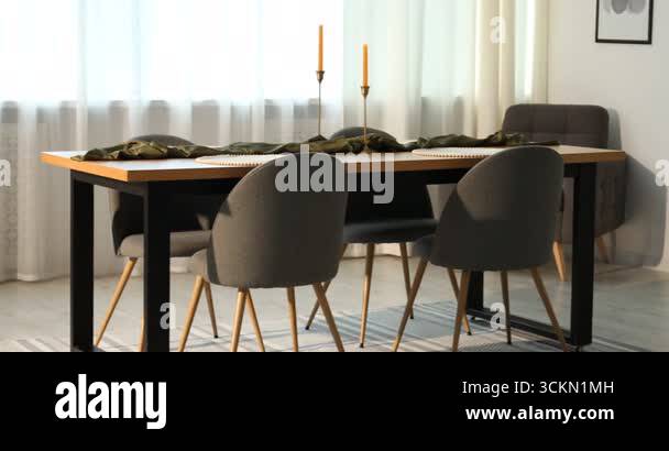 Decorated wooden table with chairs in dining room. Camera moving right ...
