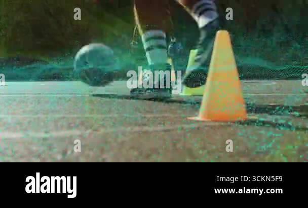 Two athletes picking up basketball and dribbling through cones in ...