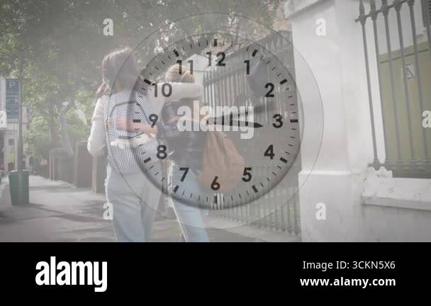 Two teenage friends meeting on sidewalk and hugging, clock overlay ...
