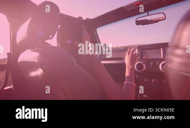 Female driver turning head and tuning stereo for music amid drifting ...