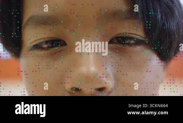 Boy holding still for face scan with colored dots flickering, capturing ...