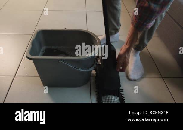 Close up of man putting cloth on mop. Illustrating inconvenient mop ...