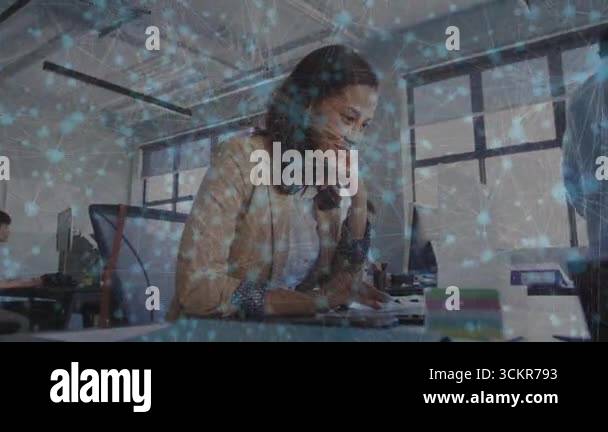 Ringing phone initiating client call while businesswoman typing notes ...