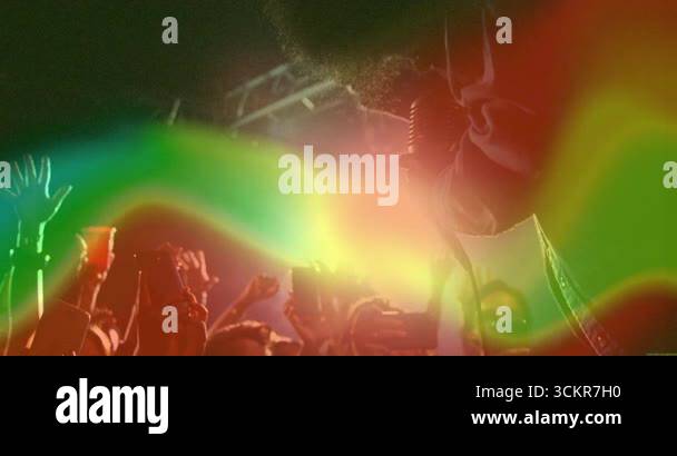 Concert singer gripping mic, leaning into crowd and engaging fans ...