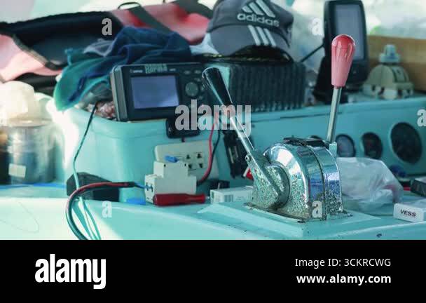 Close-up of a fishing boat's control panel with rusty levers and ...