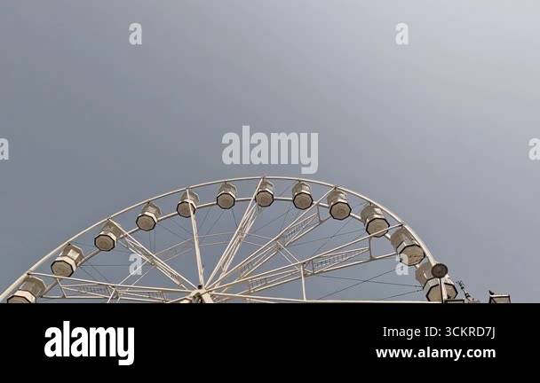 Ferris wheel rotating near iconic clock tower Stock Video Footage - Alamy