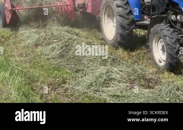 Baling hay with small square baler on a field Stock Video Footage - Alamy