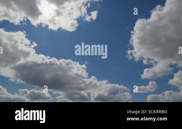 Dynamic sky view showing fluffy white clouds drifting across a bright ...