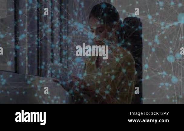 Digital network overlay appearing around woman picking up tablet and ...