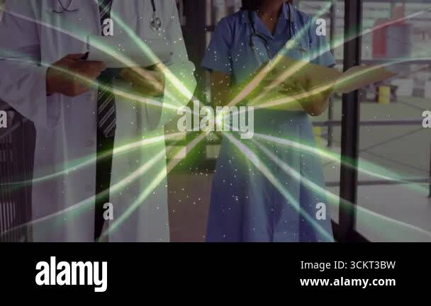Swirling green overlay revealing medical team scrolling tablet and ...