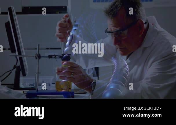 Senior scientist placing tube into clamp, pipetting sample as blue ...