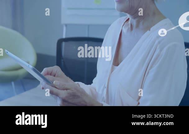 Mature adult woman tapping tablet during business meeting, generating ...