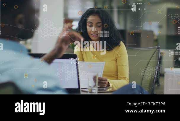 Businesswoman in yellow top receiving document and reading aloud to ...