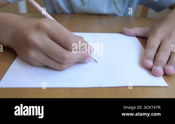 Close-up of hand drawing with a pencil on white paper. Concept of ...