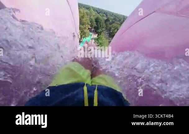 POV of an extreme free fall ride down a tall vertical waterslide. High ...