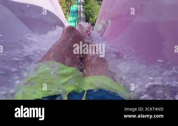 POV of an extreme free fall ride down a tall vertical waterslide. High ...
