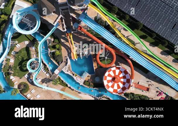Stunning drone view of a massive water park filled with colorful slides ...