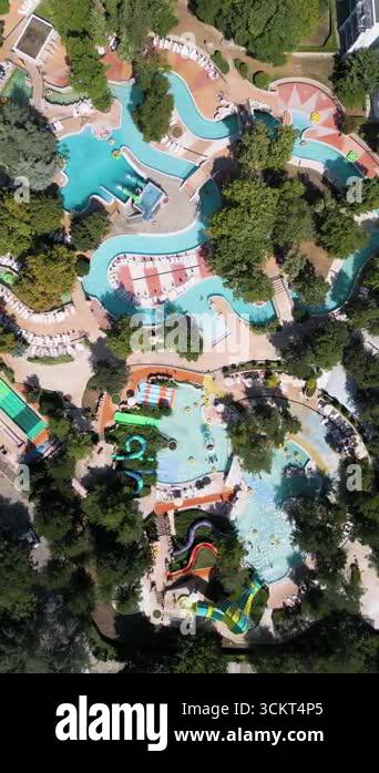 Aerial view of a relaxing water park with interconnected pools, lazy ...